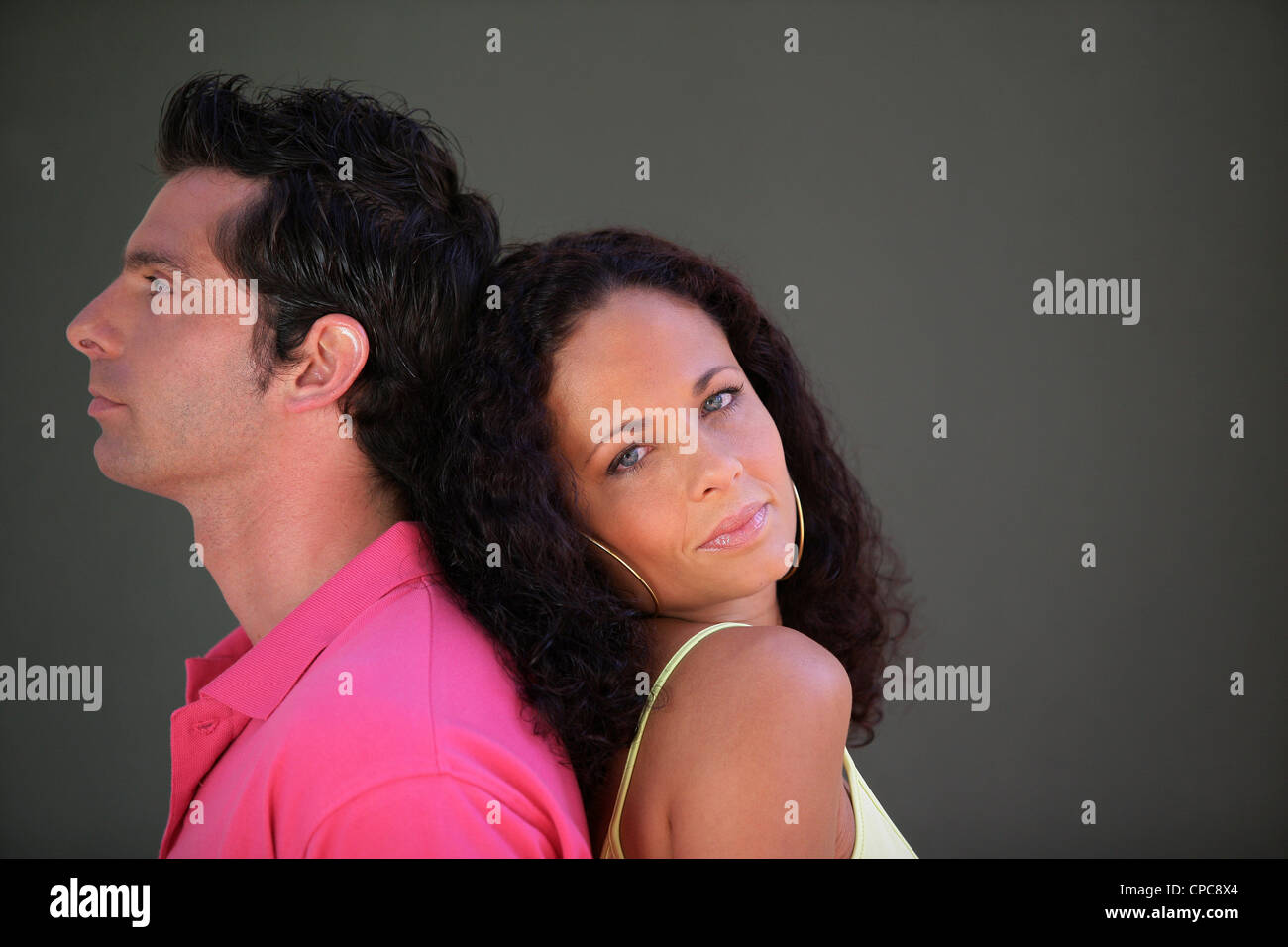 Couple stood back to back Stock Photo - Alamy