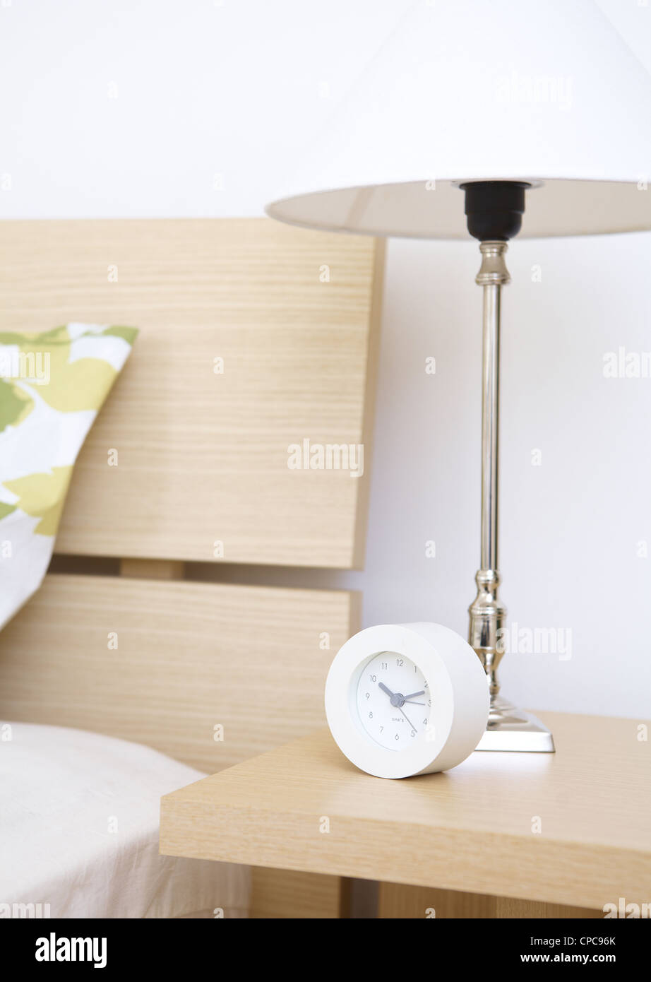 Stand clock on a side table Stock Photo - Alamy