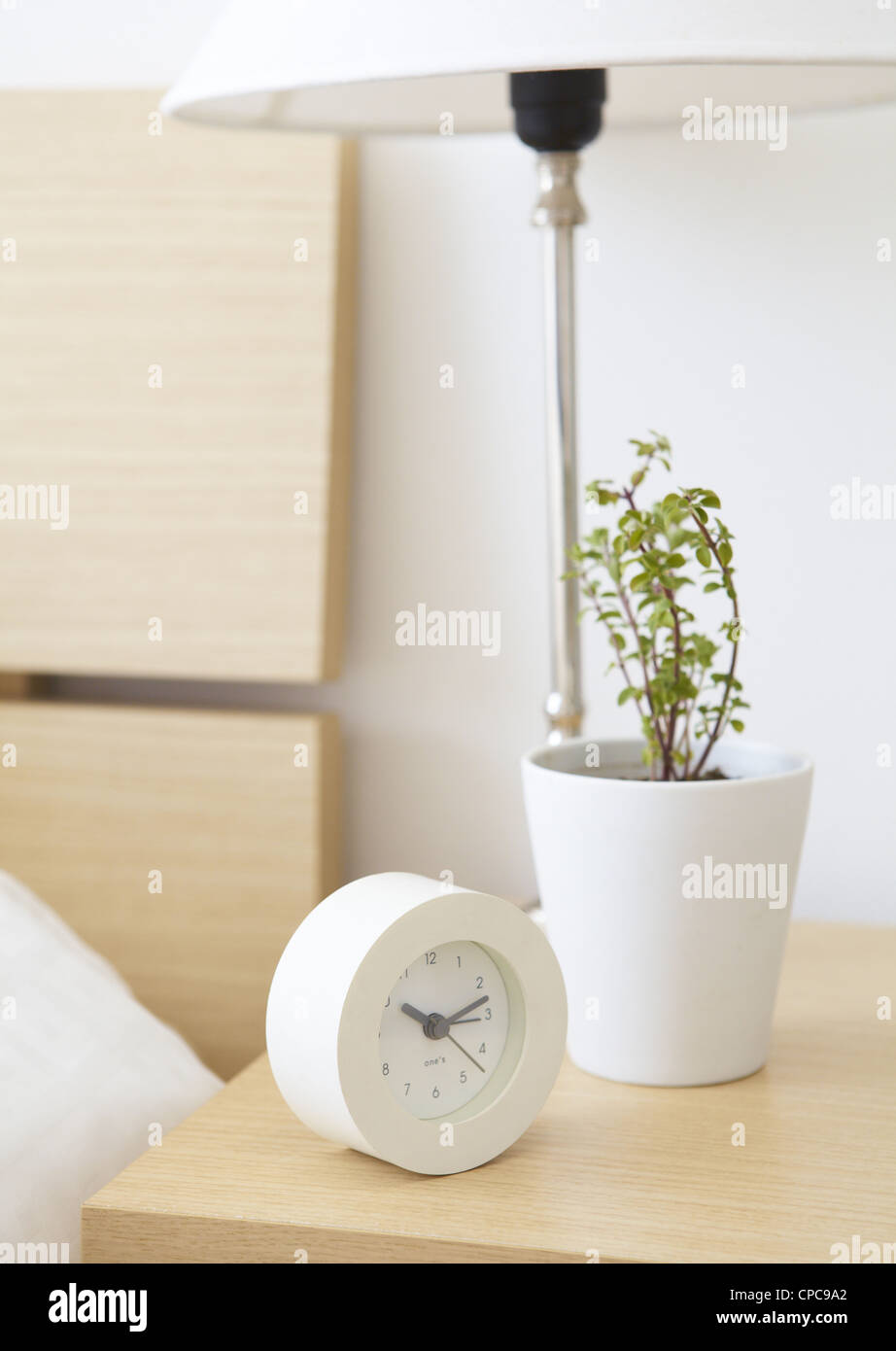 Stand clock on a side table Stock Photo - Alamy