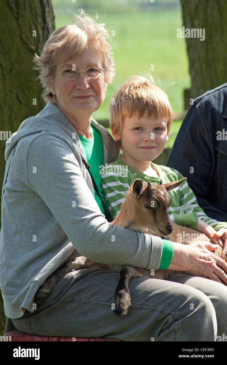 grandmother and grandson cuddling a goose Stock Photo - Alamy