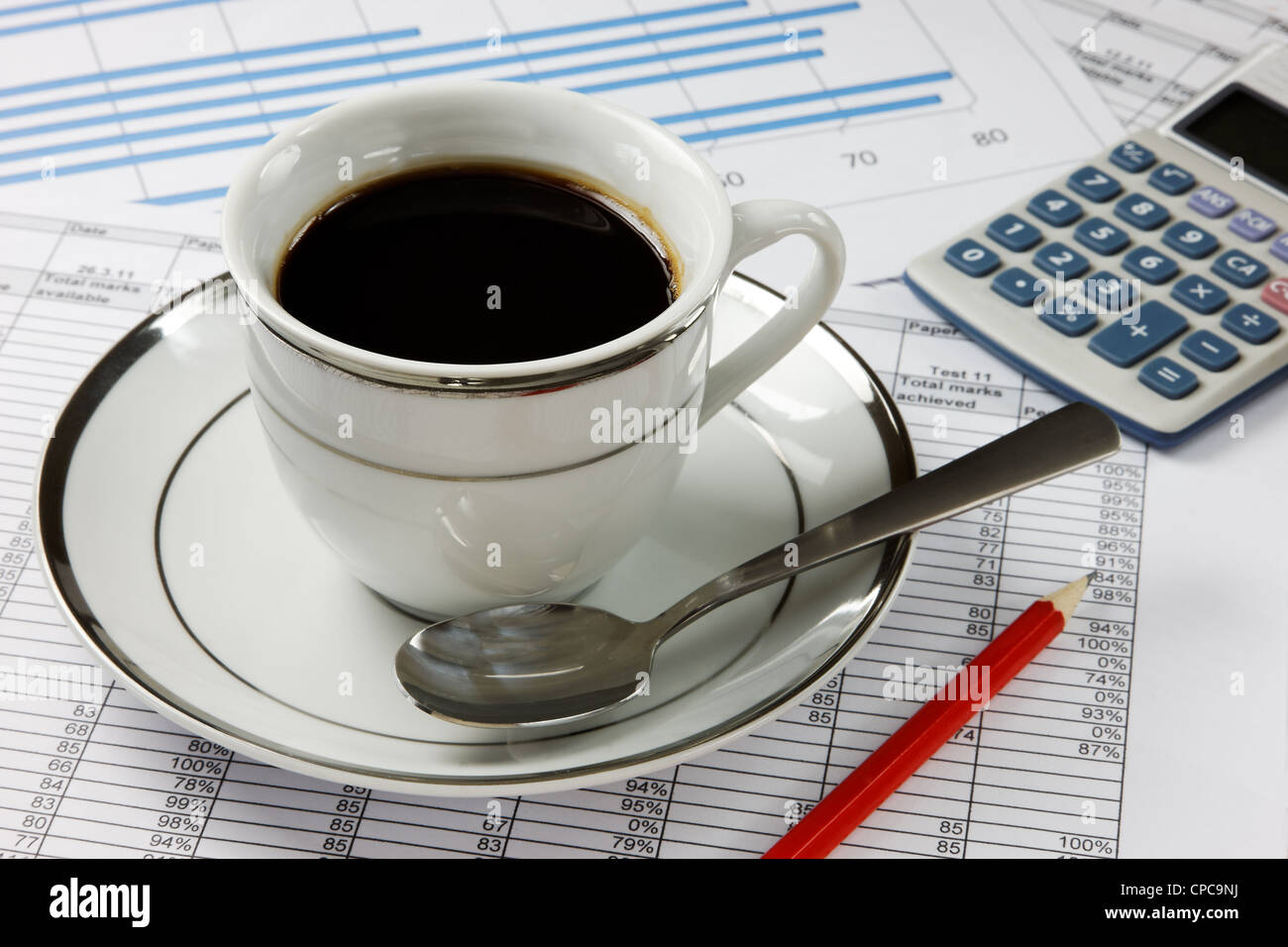 A cup of black coffee on spreadsheets with calculator and pencil Stock ...