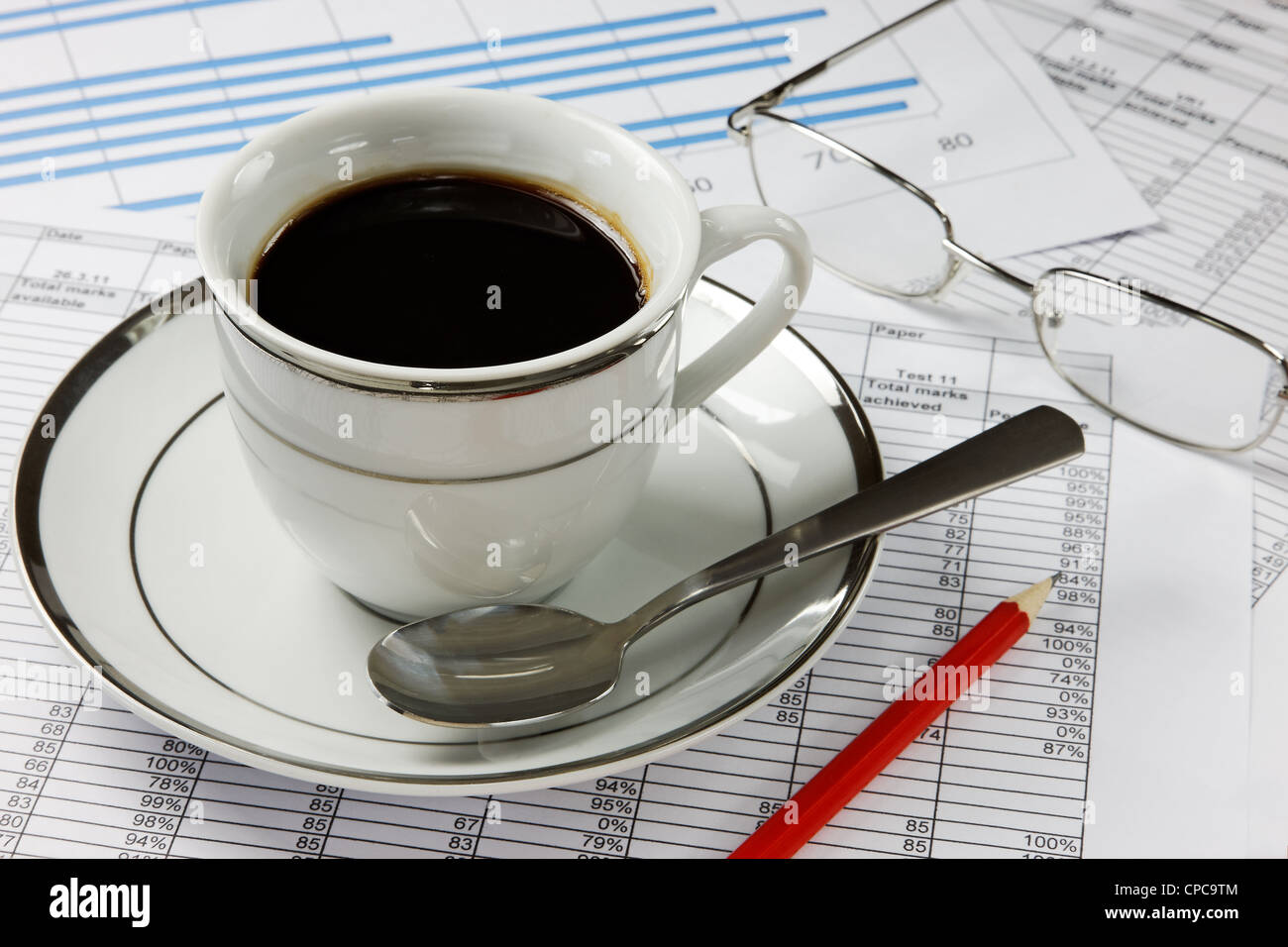 A cup of black coffee on spreadsheets with glasses and pencil Stock ...