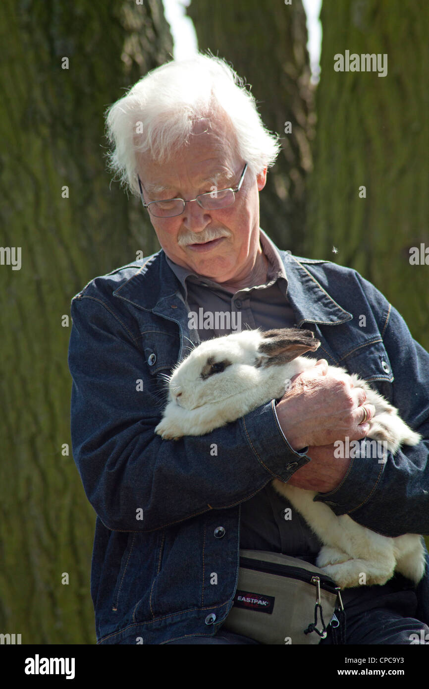 elderly man cuddling a rabbit Stock Photo - Alamy