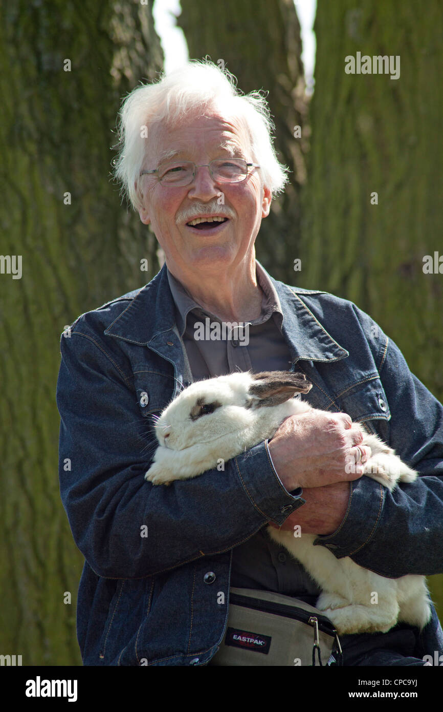 elderly man cuddling a rabbit Stock Photo - Alamy