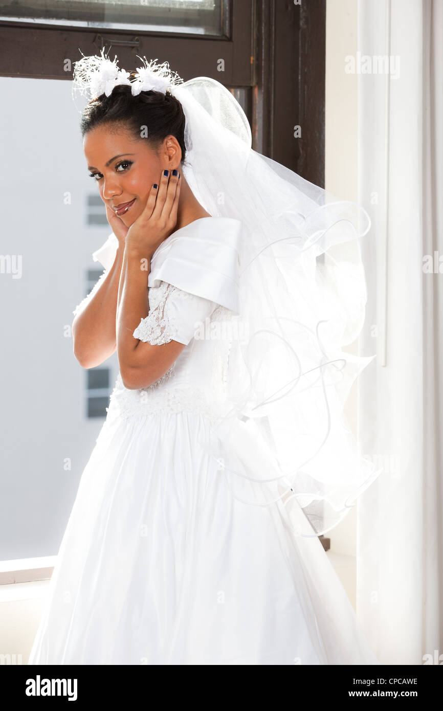 Beautiful Bride lit up from light showering her from the open window ...