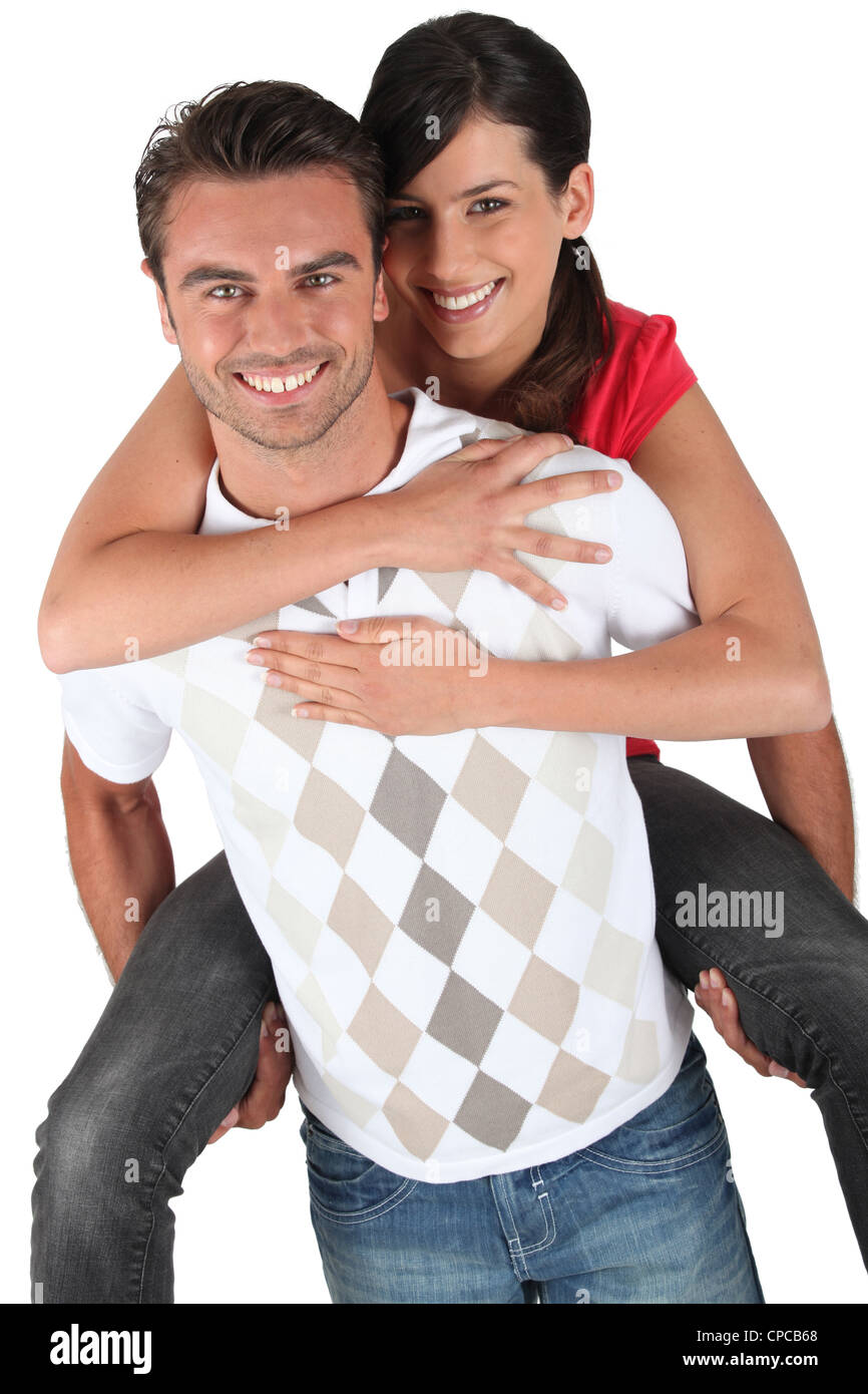 Man giving girlfriend piggyback Stock Photo - Alamy