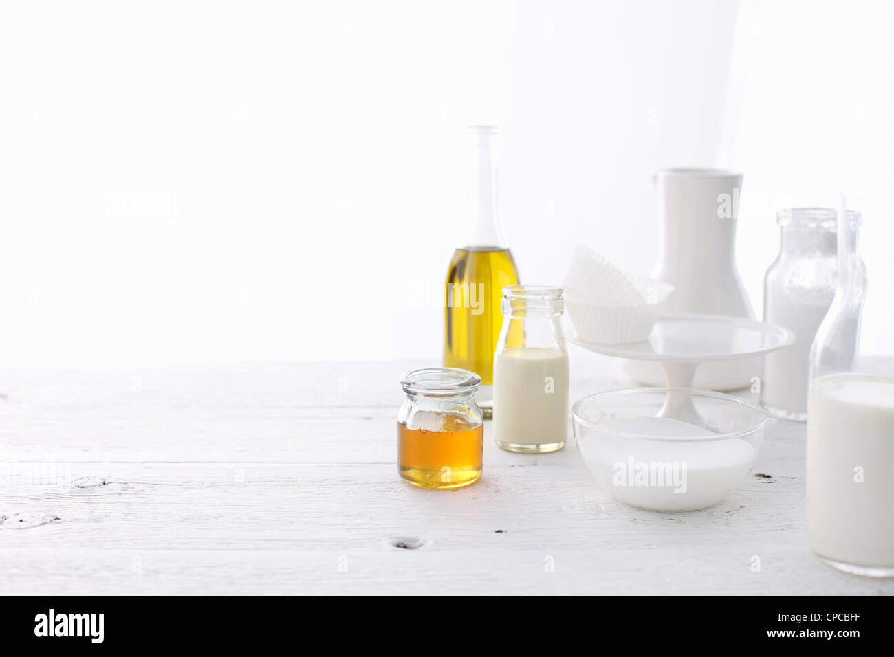 Bottles of oil and milk on table Stock Photo - Alamy