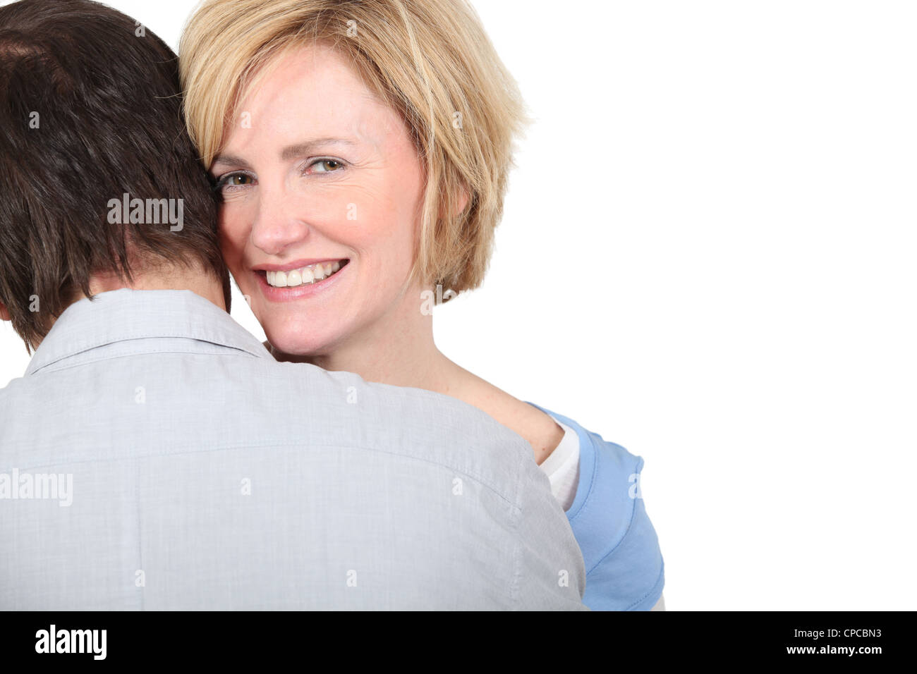 Smiling woman embracing her partner Stock Photo - Alamy