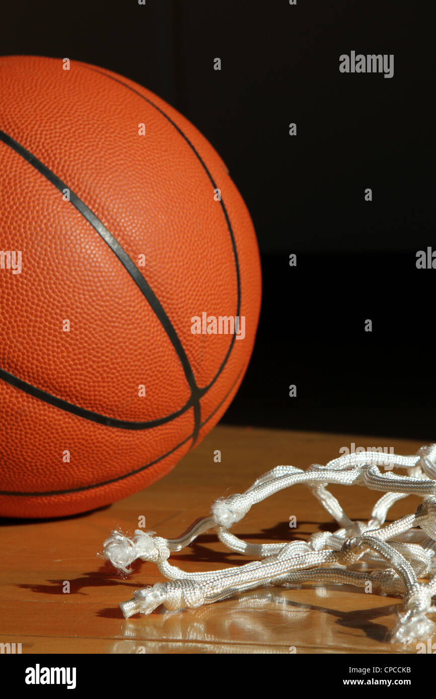 A close up of a basketball and a net Stock Photo - Alamy