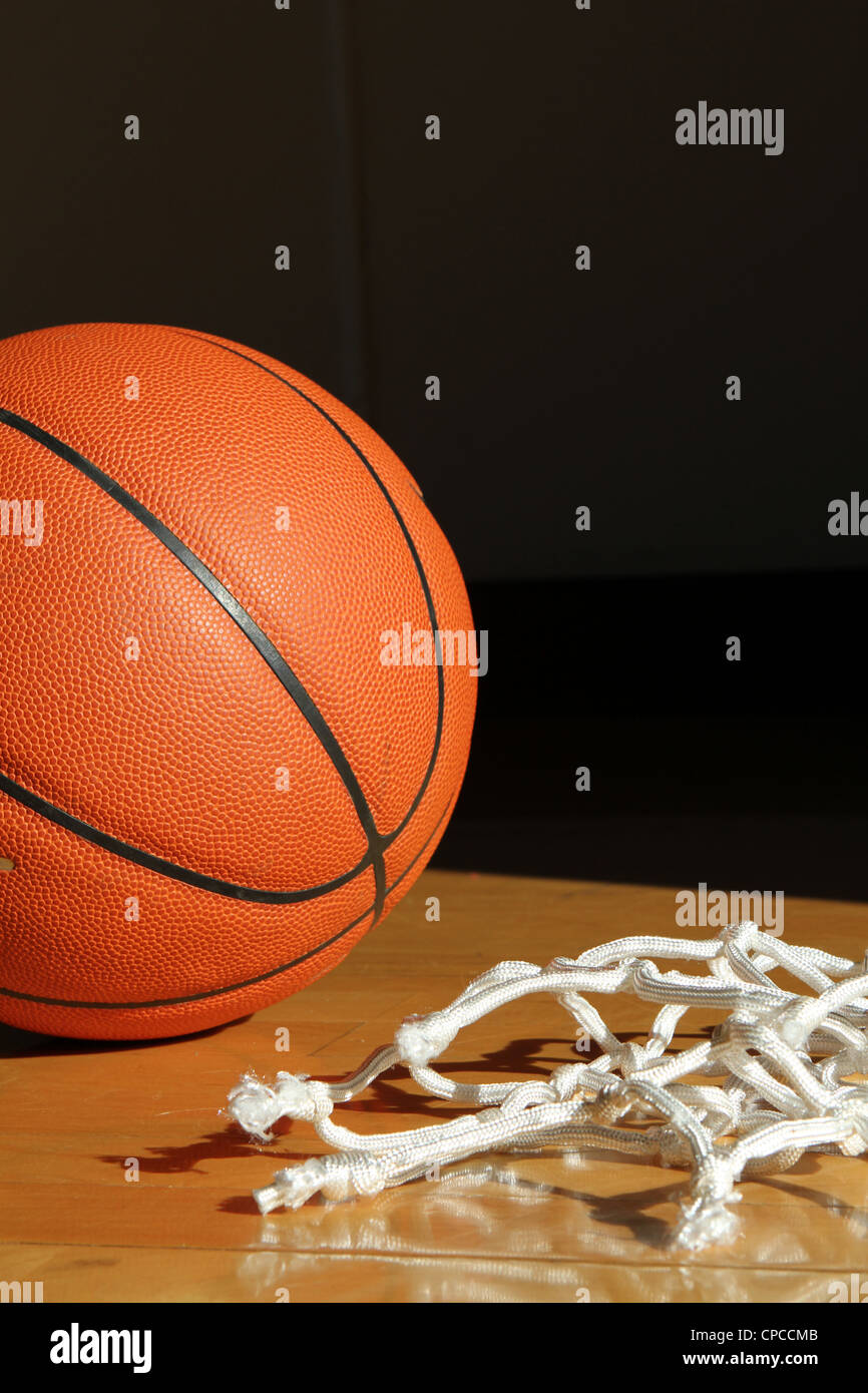 A close up of a basketball and a net Stock Photo - Alamy