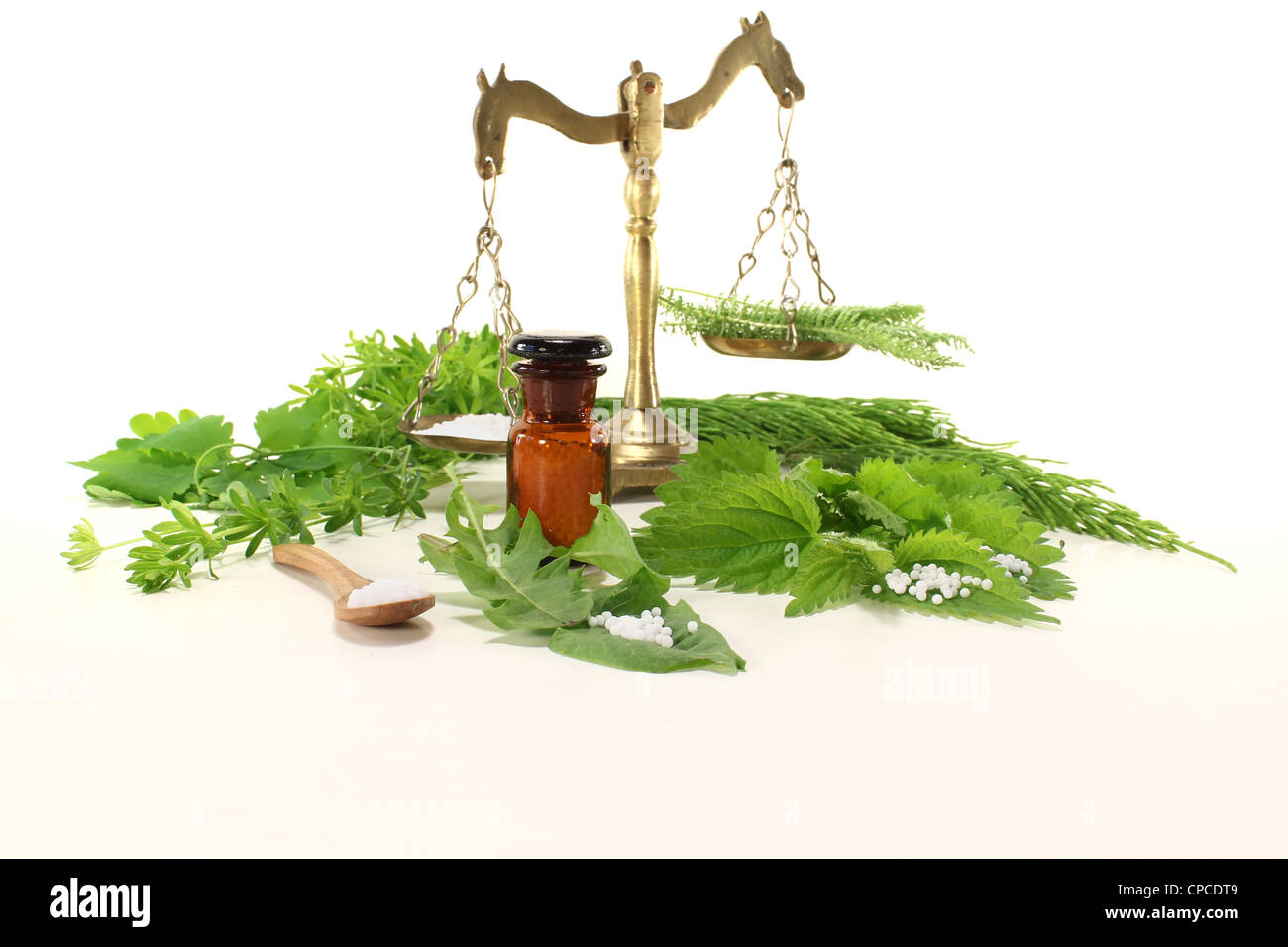 Homeopathy globules, an apothecary jar and scale, and fresh natural ...
