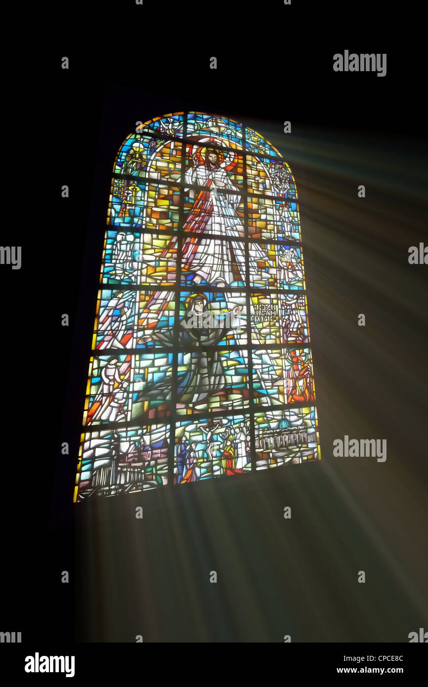 Biblical stained glass with rays of light shining through Stock Photo ...