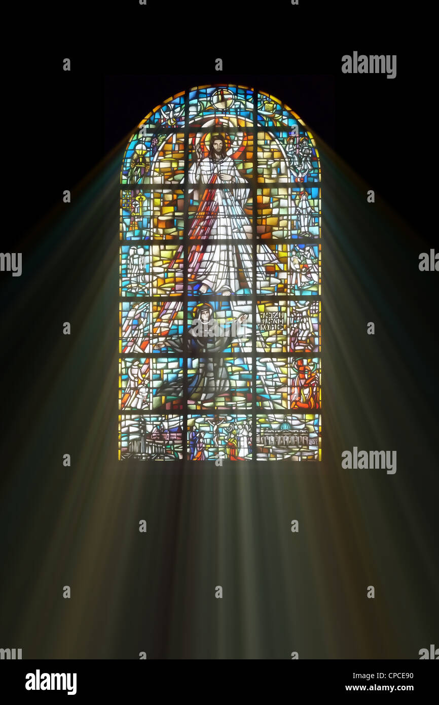 Biblical stained glass with rays of light shining through Stock Photo ...