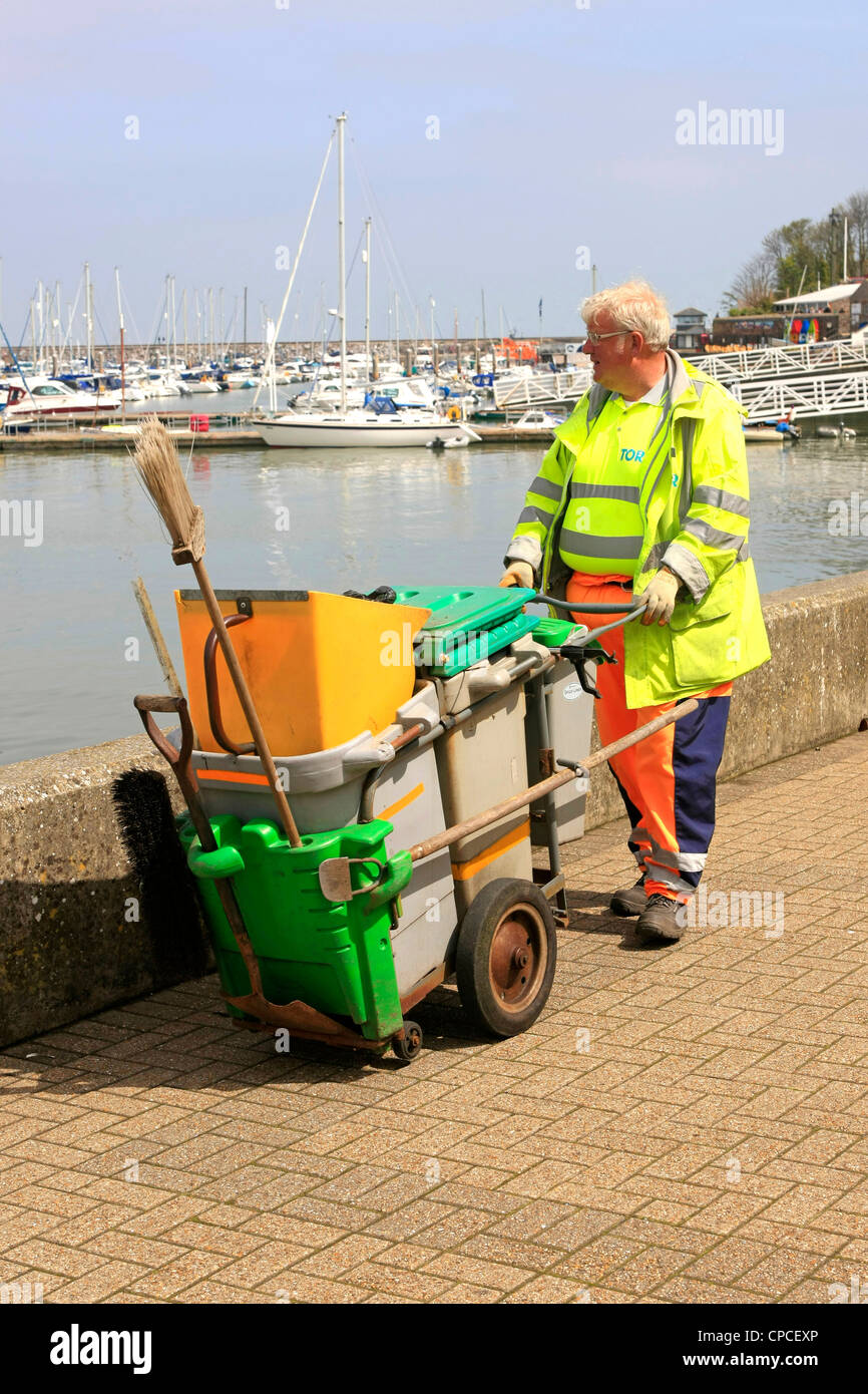 A Street sweeper with his cart in Brixham Devon Stock Photo - Alamy