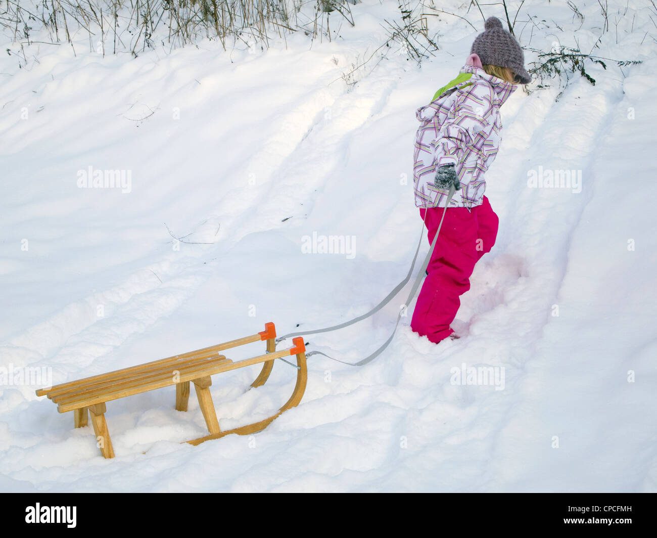 The girl with sled Stock Photo - Alamy