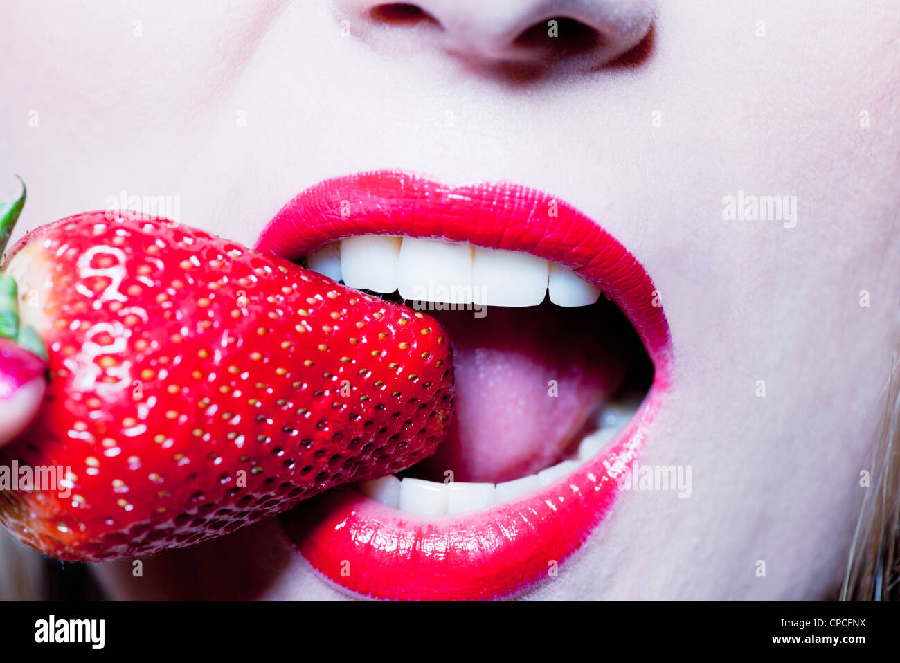 close up of woman eating a strawberry Stock Photo - Alamy