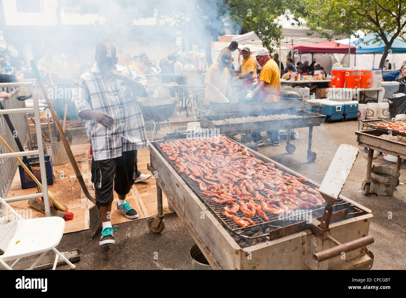 A man cooking on large barbecue Stock Photo - Alamy