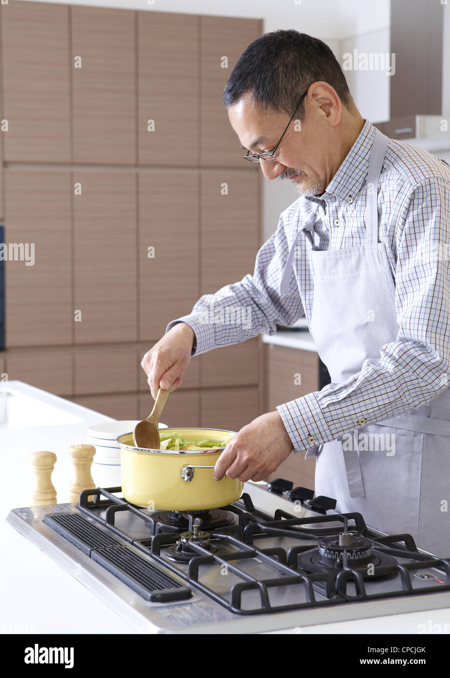 Senior man cooking Stock Photo - Alamy