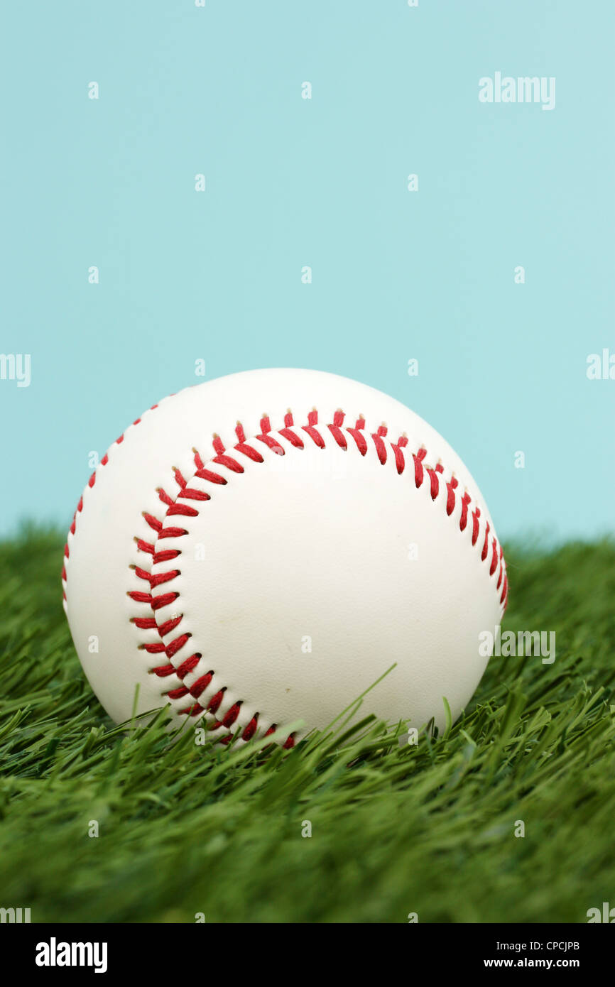 Baseball In The Green Grass With Blue Sky Stock Photo - Alamy