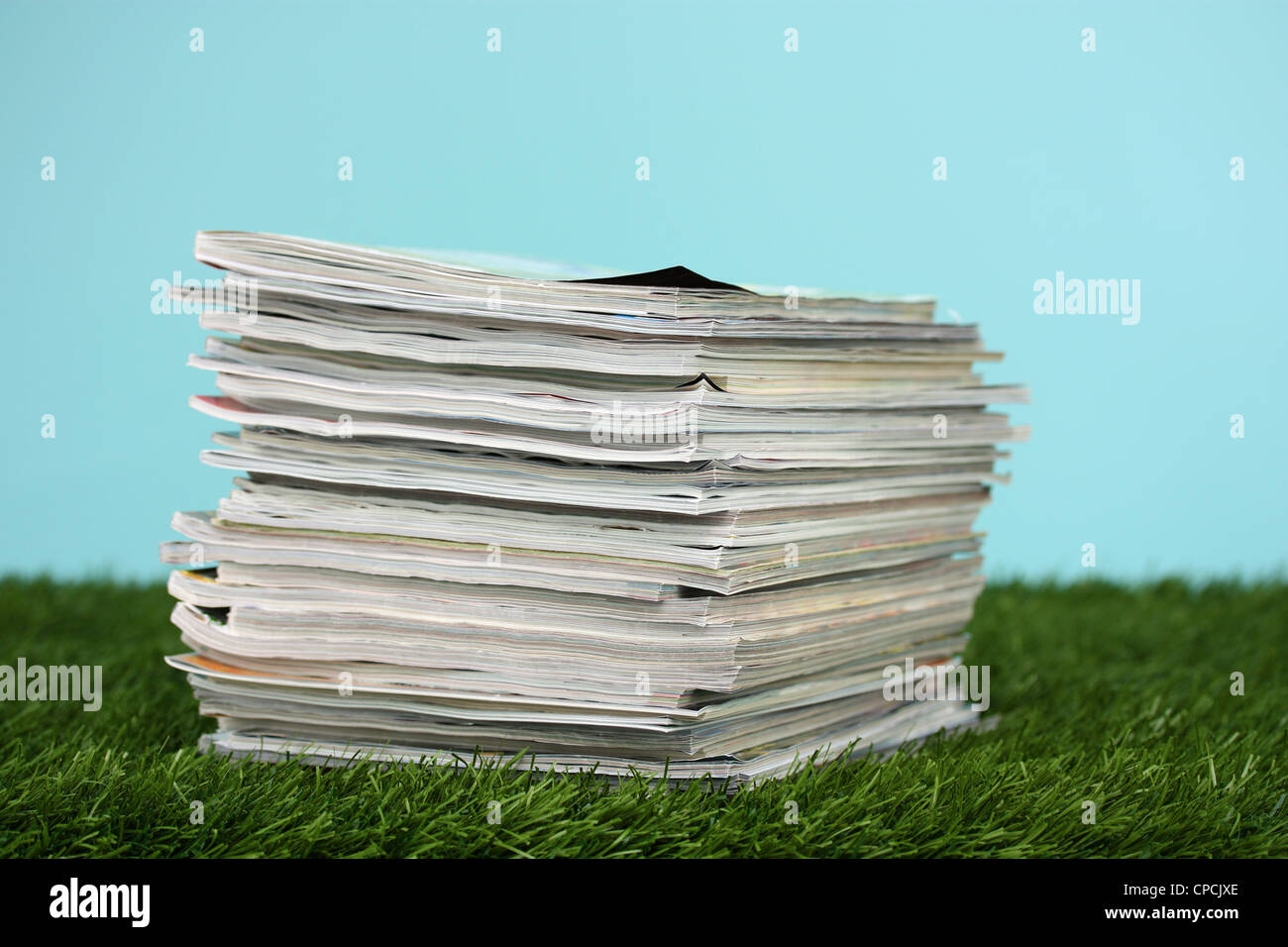 Stack Of Magazines On Green Grass Outside Stock Photo - Alamy