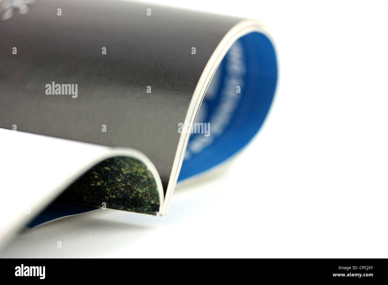 Magazine open sitting on a white background Stock Photo - Alamy