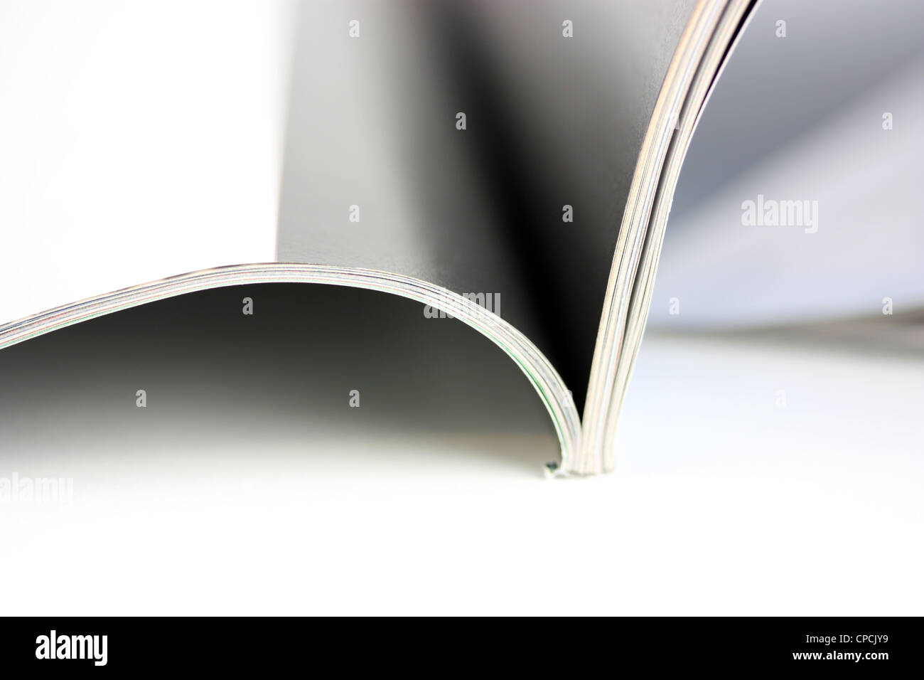 Magazine open sitting on a white background Stock Photo - Alamy