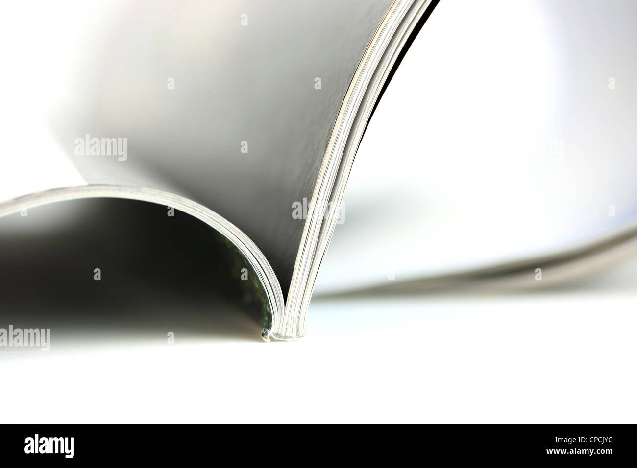 Magazine open sitting on a white background Stock Photo - Alamy