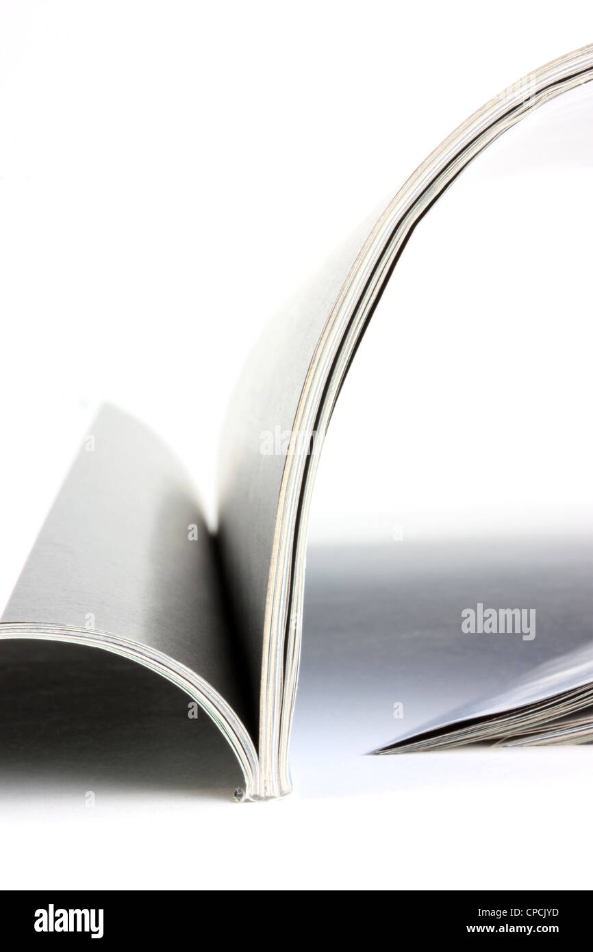 Magazine open sitting on a white background Stock Photo - Alamy