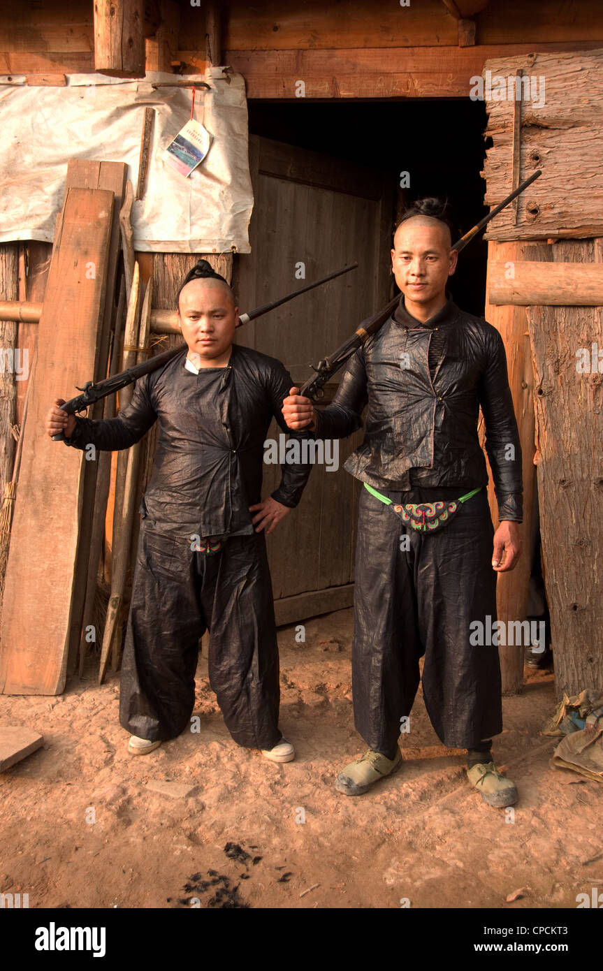 Two young Basha Miao men (Gun Men) with traditional hairstyles and ...