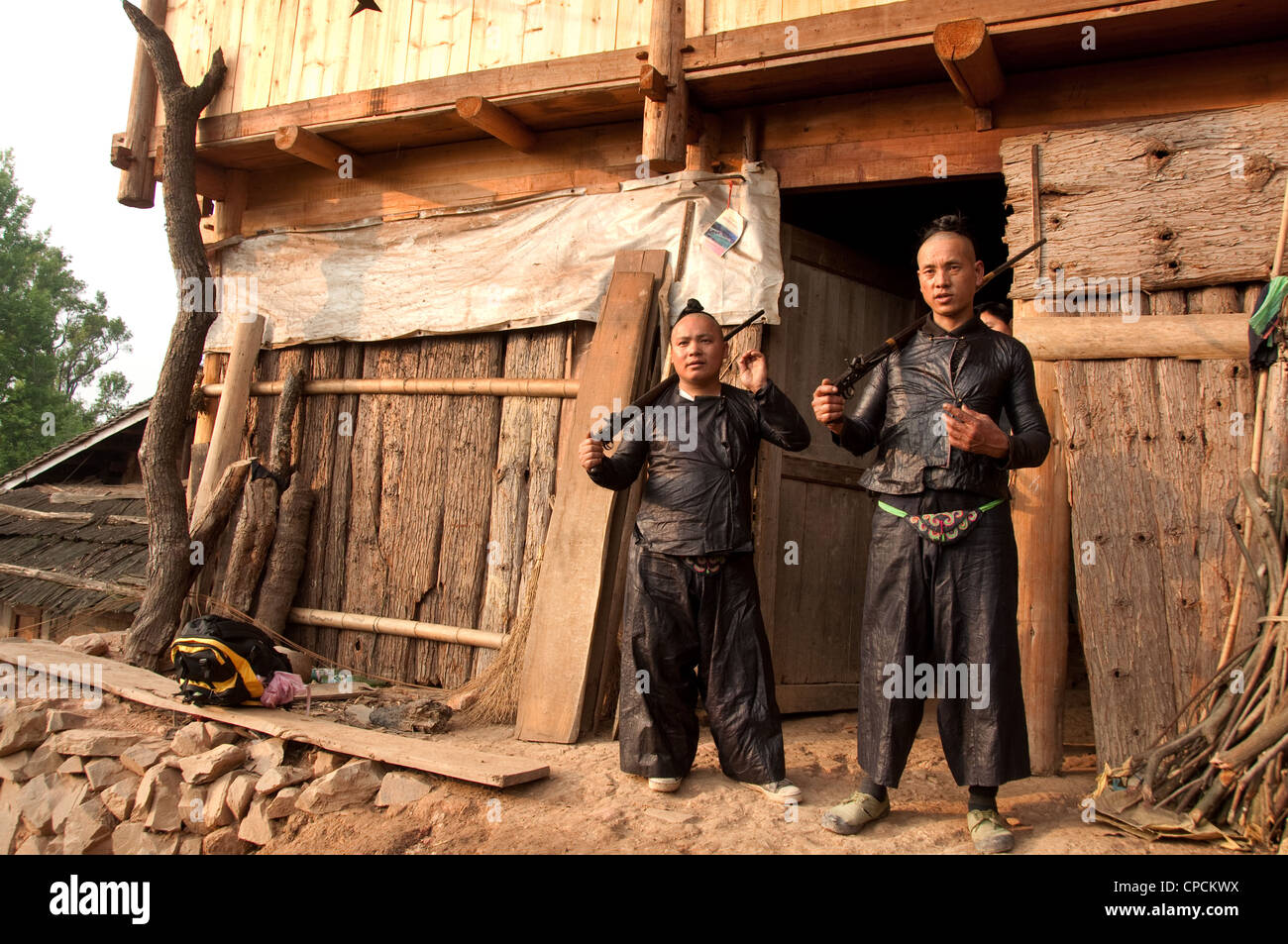 Two young Basha Miao men (Gun Men) with traditional hairstyles and ...