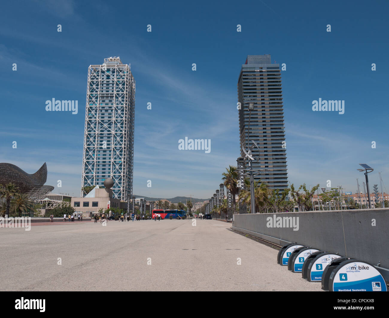 Twin hi-rise tower blocks at Barcelona beach front, with empty bicycle ...