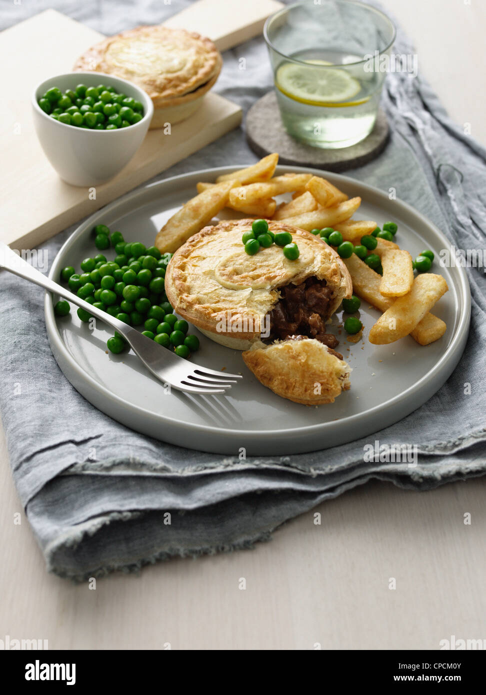 Plate of meat pie, chips and peas Stock Photo - Alamy