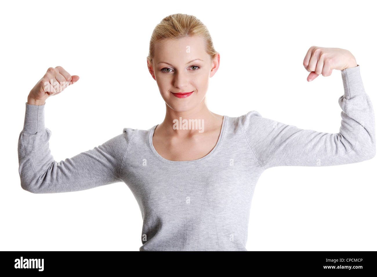 Cute young smiling woman showing her biceps, isolated on white ...