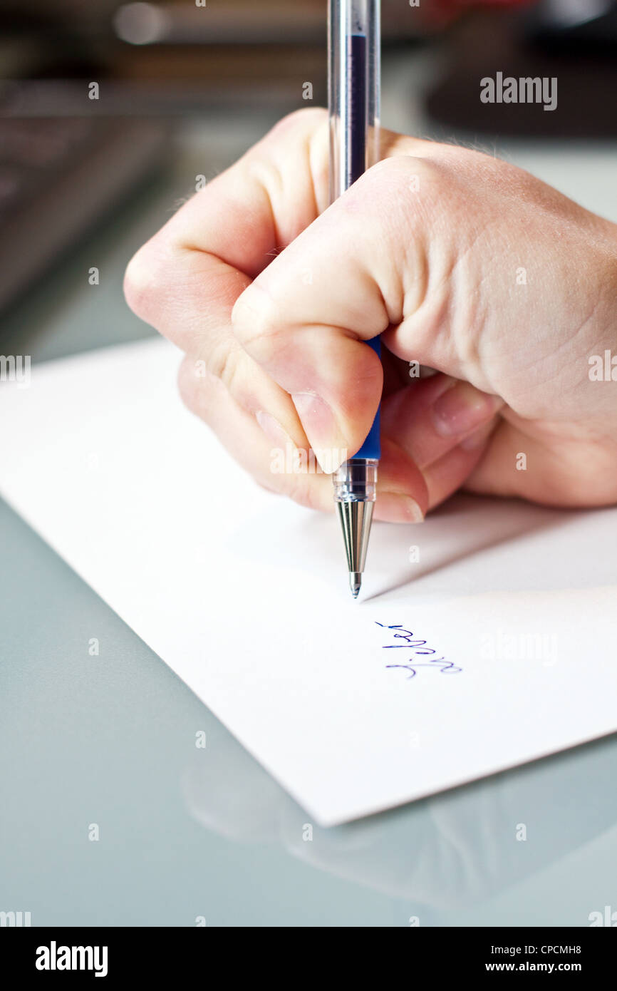 womans hand is writing a letter with a pen Stock Photo - Alamy