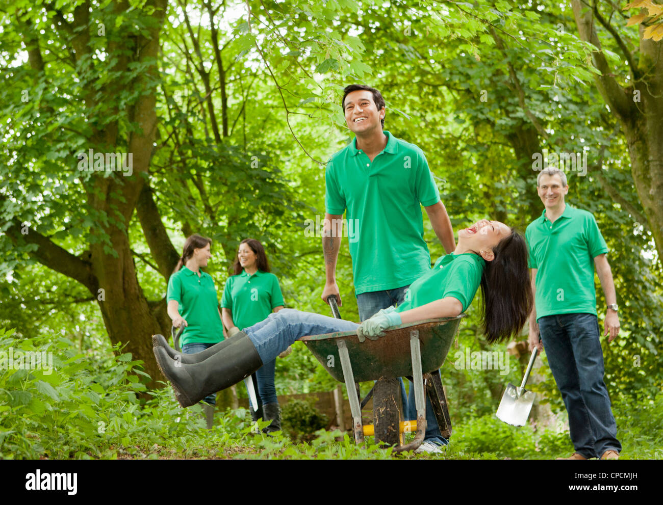 Gardeners playing together in park Stock Photo - Alamy