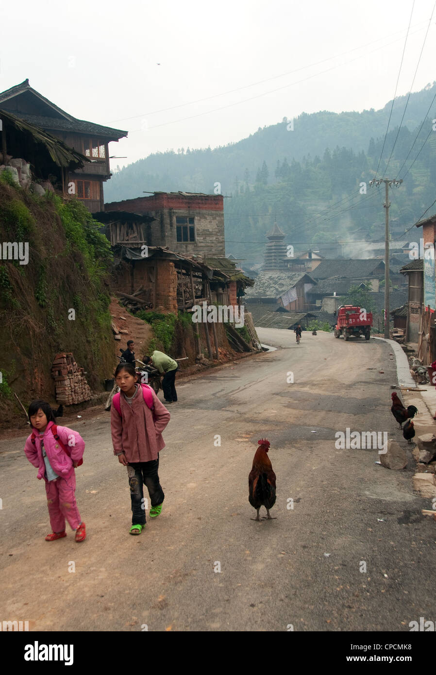 Children and chickens on the street of a Dong people village, Southern ...
