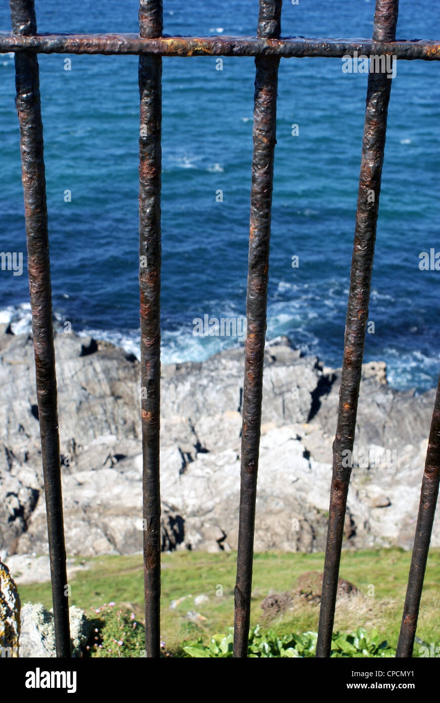 Rusty bars above cliff Stock Photo - Alamy