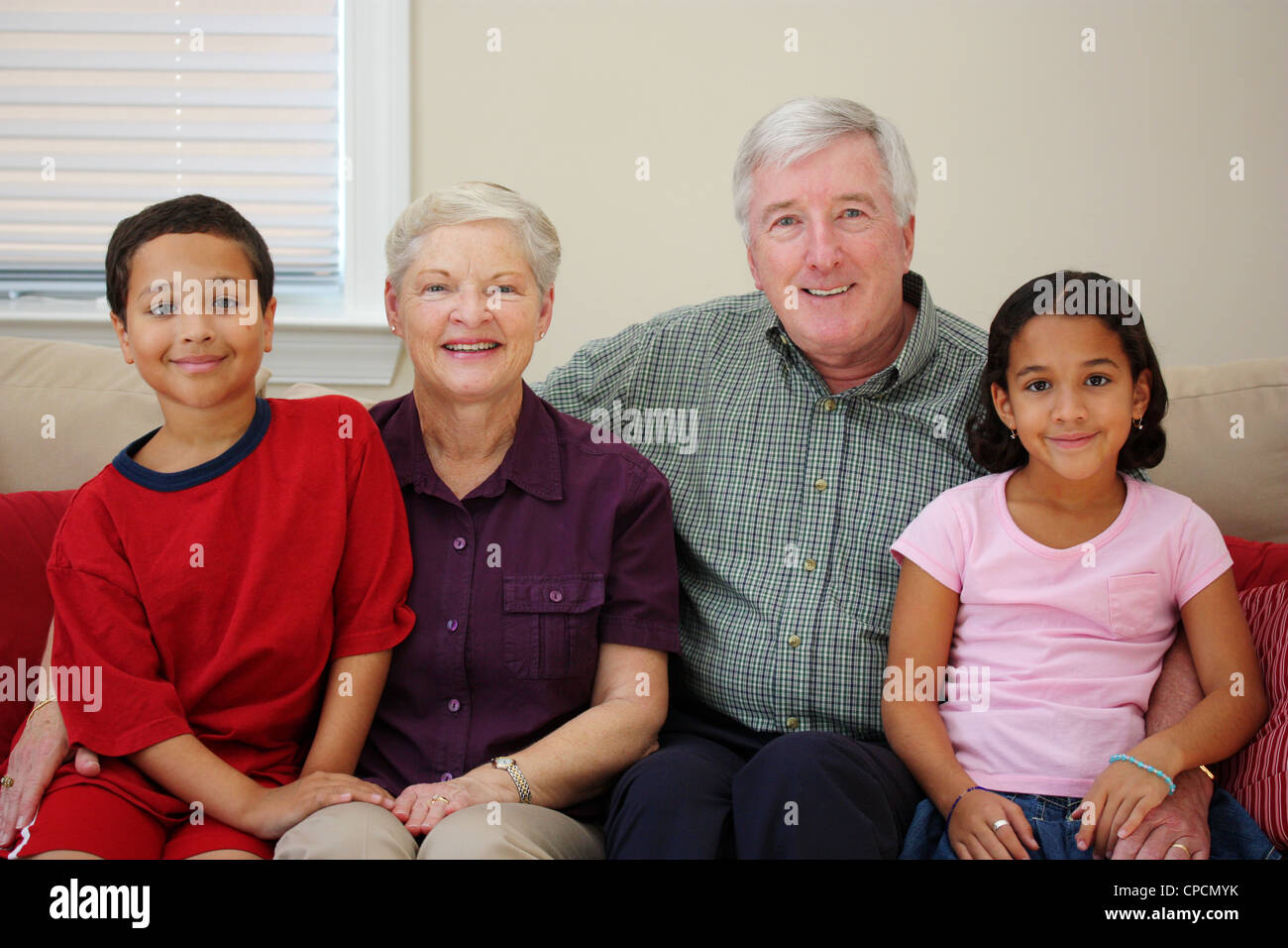 Grandparents together with their family at home Stock Photo - Alamy