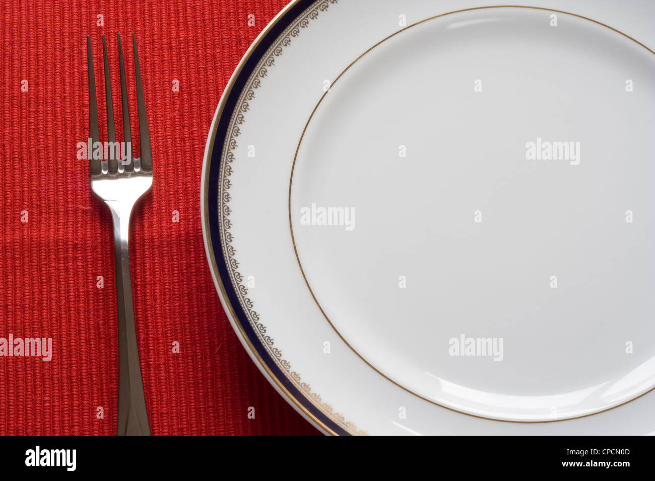 fork and porcelain plate over red (copy space in the plate Stock Photo ...