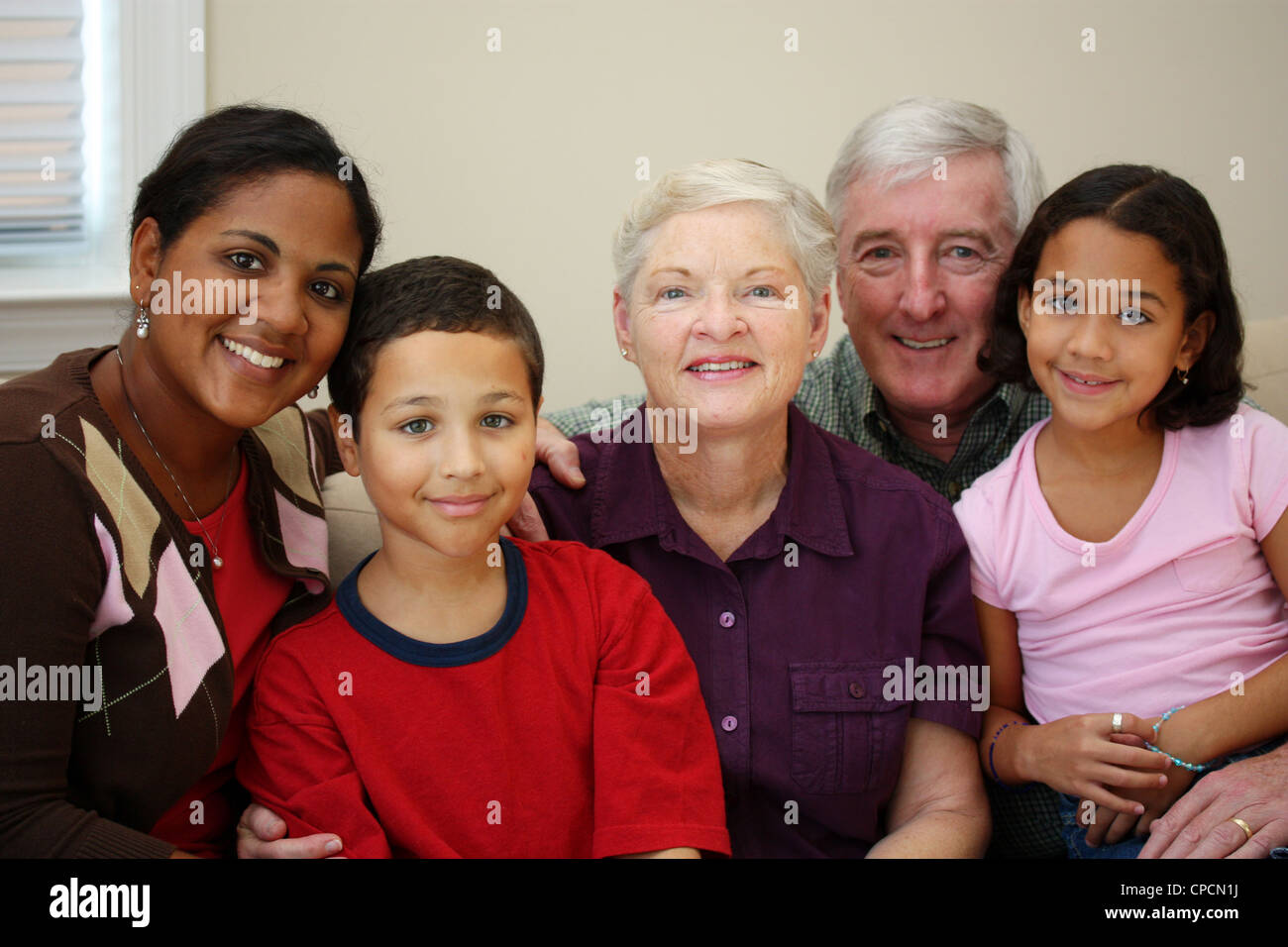 Grandparents together with their family at home Stock Photo - Alamy