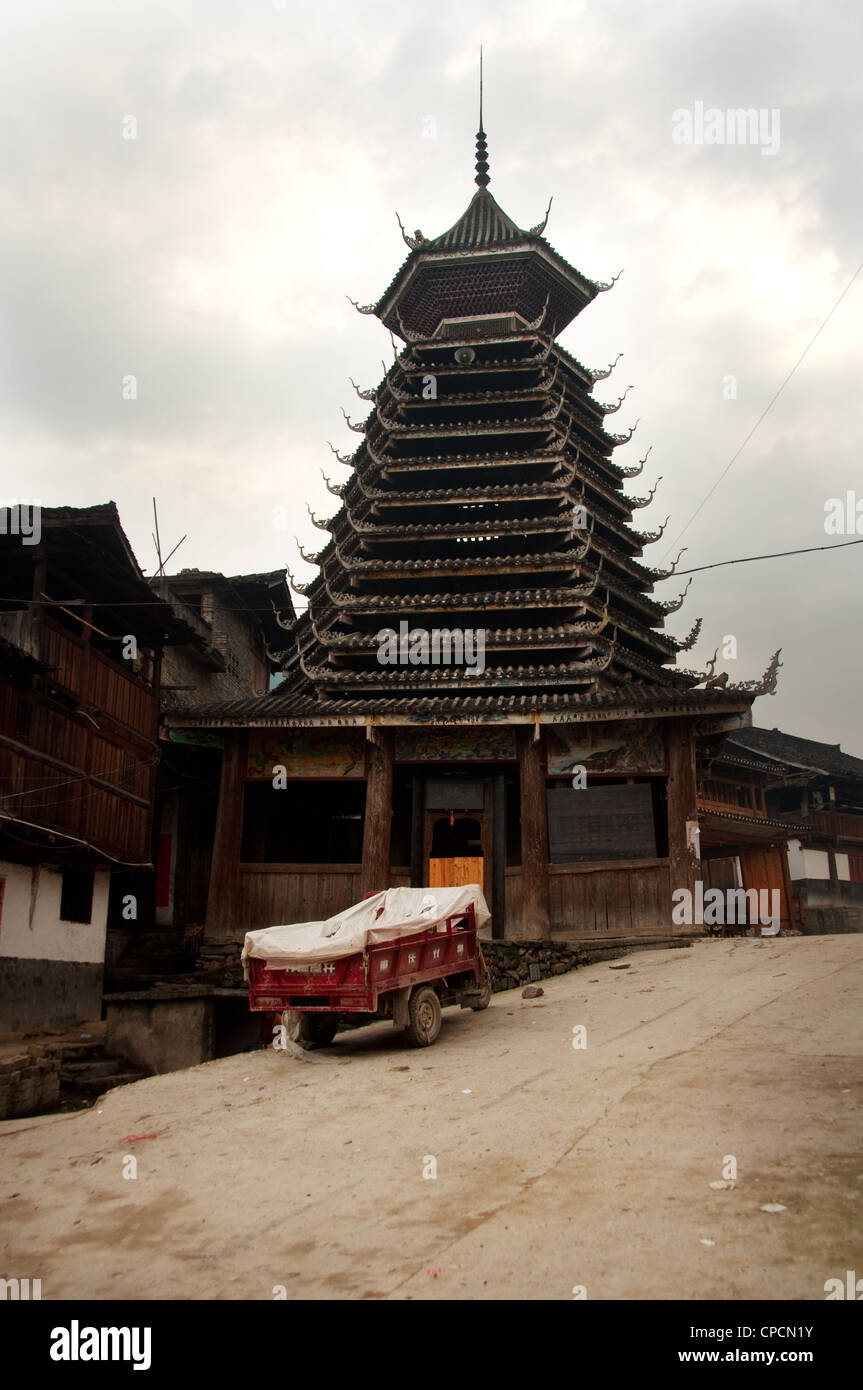 A Drum Tower and a three-wheeler on the street, Dong people village ...