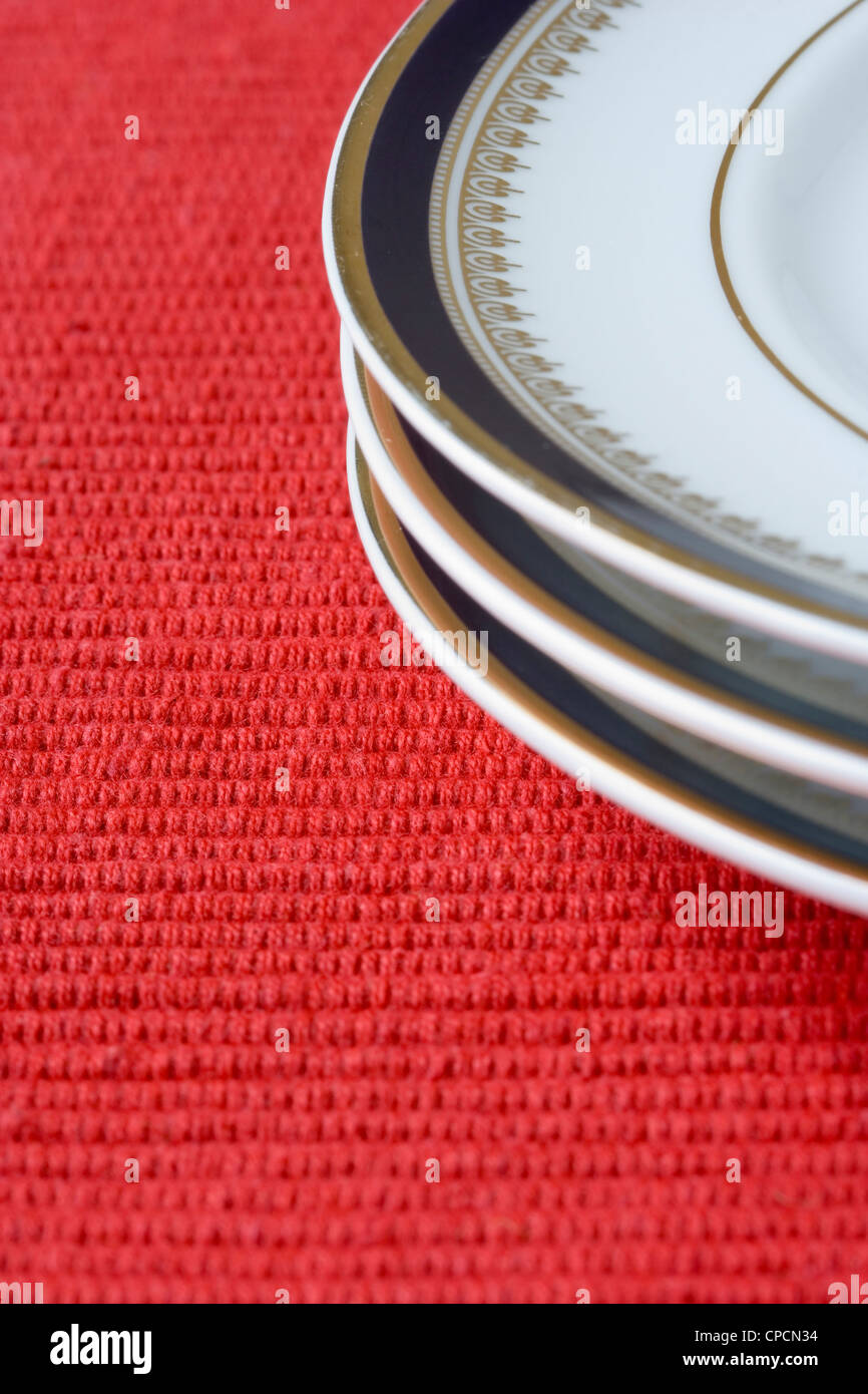 porcelain plates in a perspective over red (selective and soft focus ...
