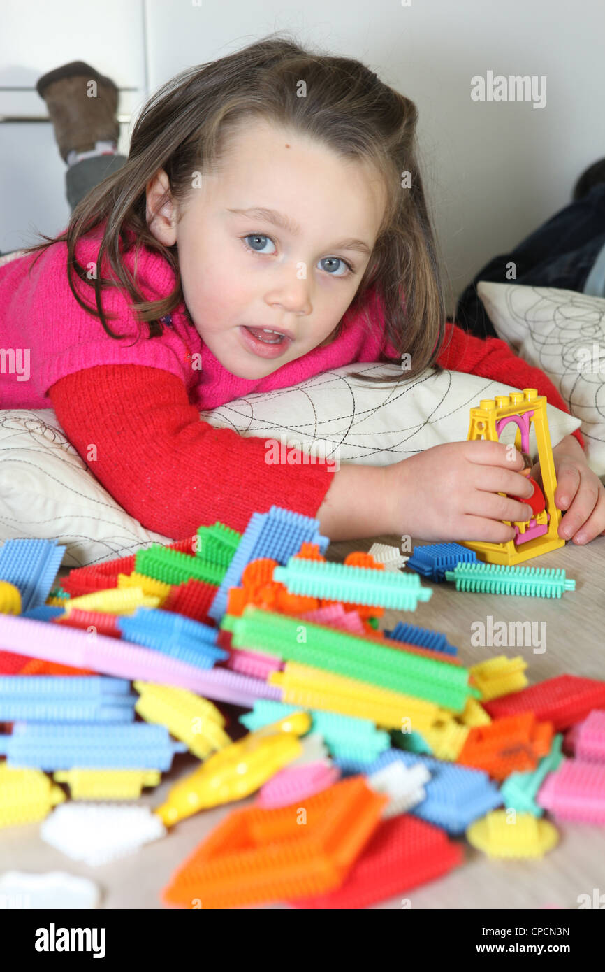 Little girl playing with building blocks Stock Photo - Alamy