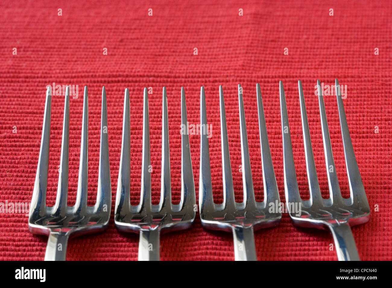 four forks in perspective with a red background (selective and soft ...