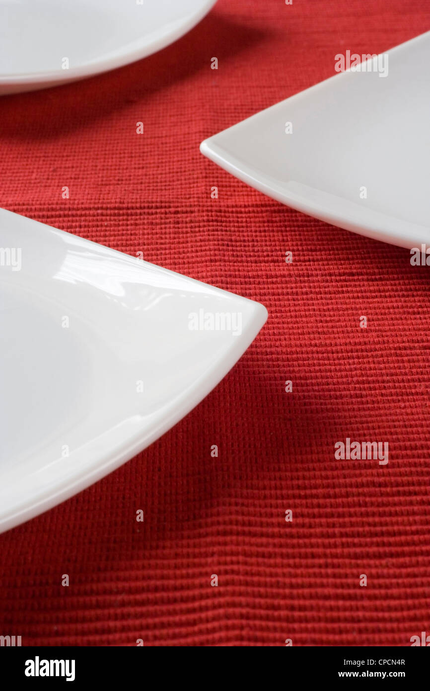 porcelain plates in a perspective over red (selective and soft focus ...