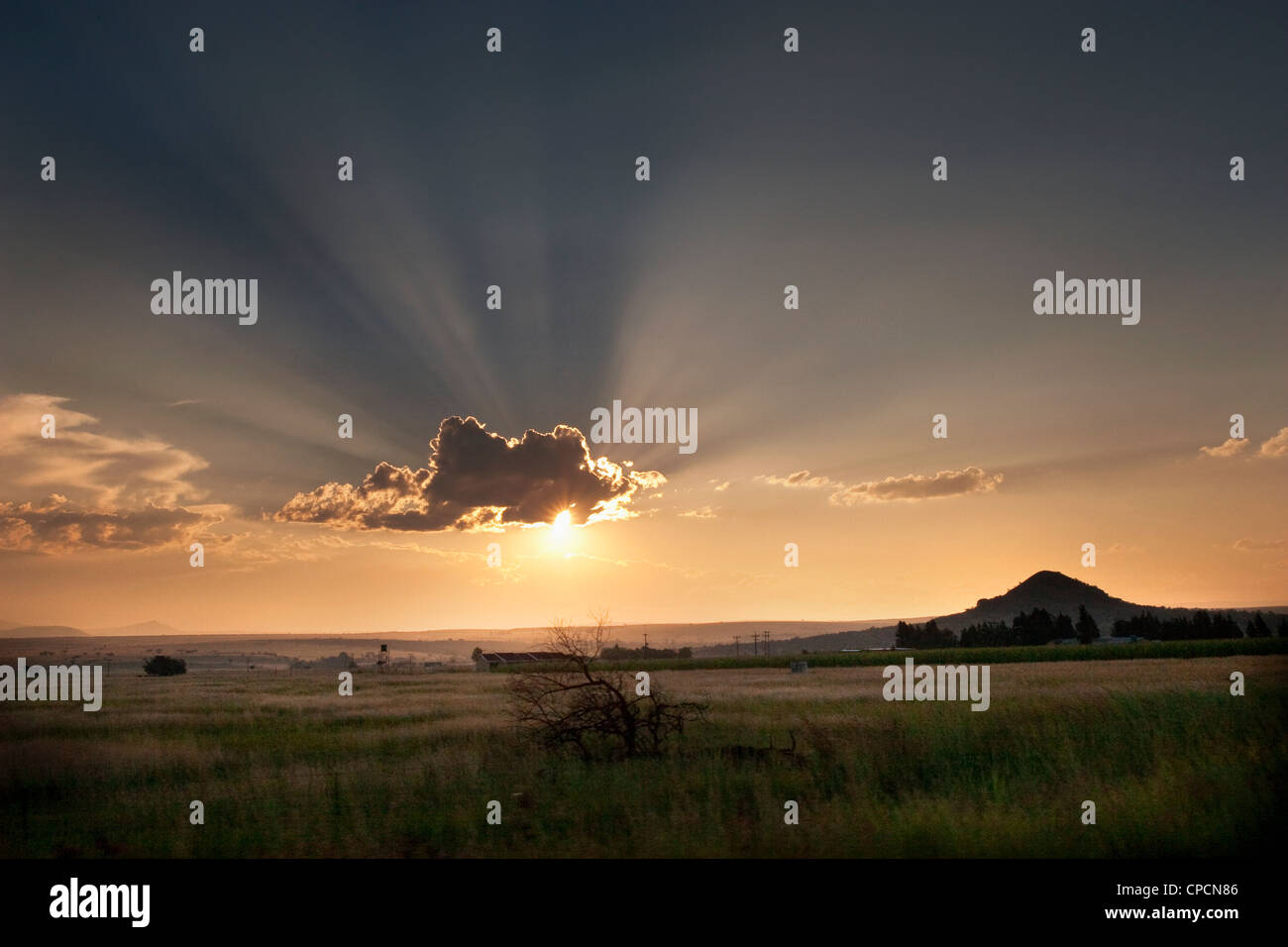 Sun shining through clouds Stock Photo - Alamy