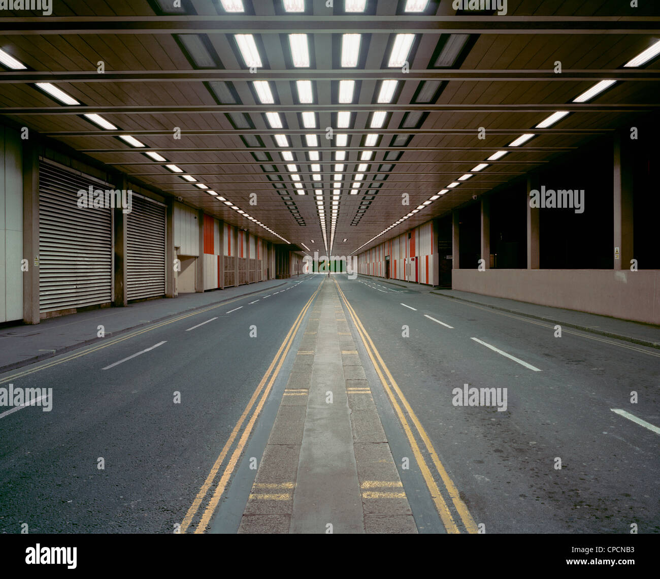 Illuminated road in parking structure Stock Photo - Alamy