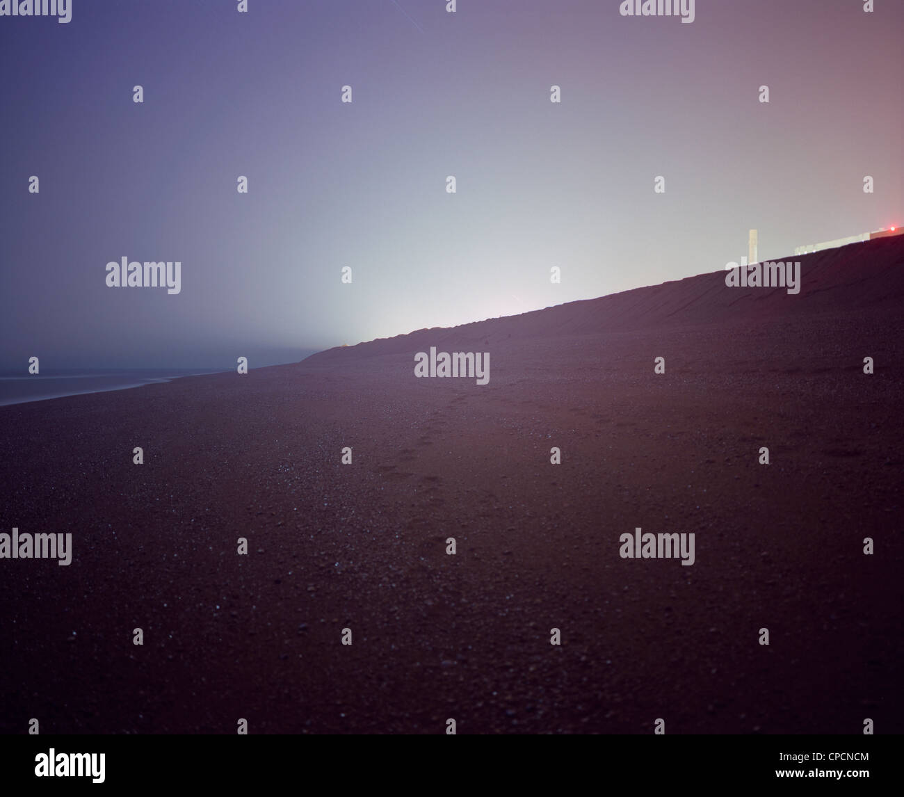 Sun rising over sandy beach Stock Photo - Alamy