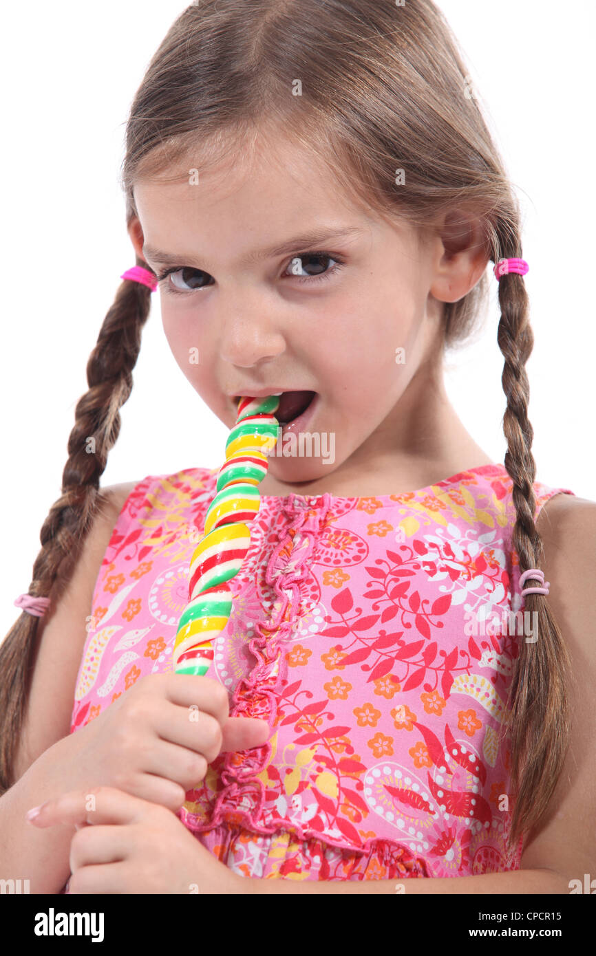 Girl eating a lolly pop Stock Photo - Alamy