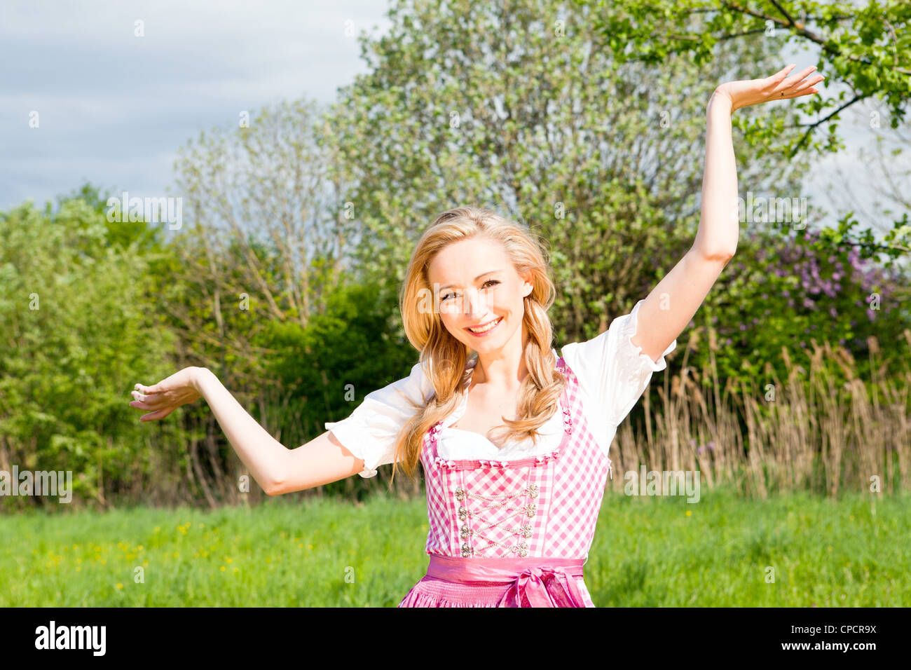young woman with pink dirndl outdoor in summer Stock Photo - Alamy